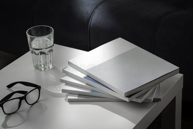 Eyeglasses with Stack of Books, and the Glass of Water on the Table ...