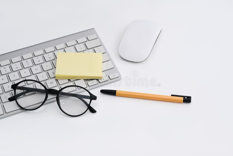 Eyeglasses, Sticky Note, Wireless Keyboard Ad Mouse on White Office ...