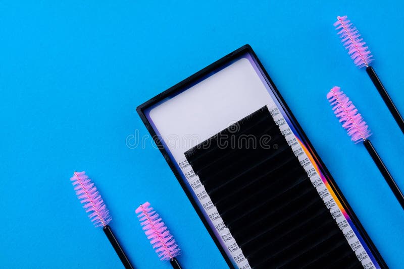 Eyelash Extensions and Brushes on Blue Background Stock Image - Image ...