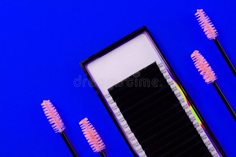 Eyelash Extensions and Brushes on Blue Background Stock Photo - Image ...