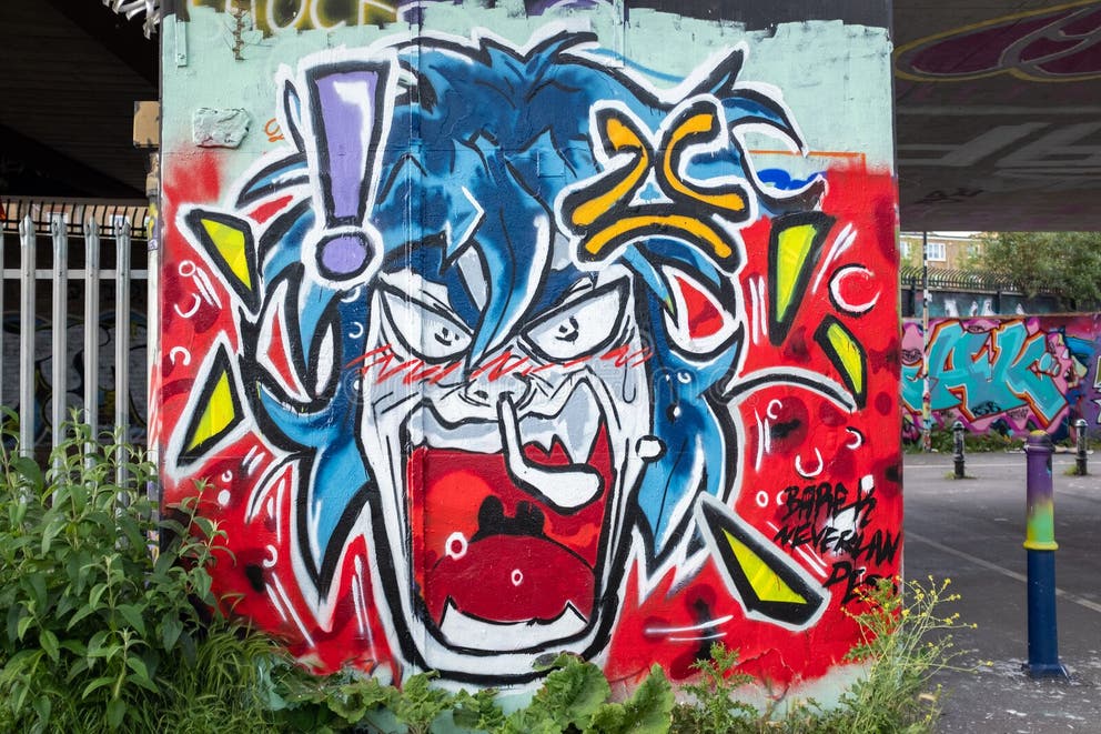 Graffiti on a Wall Features a Vivid, Exaggerated Cartoon Face with Blue ...