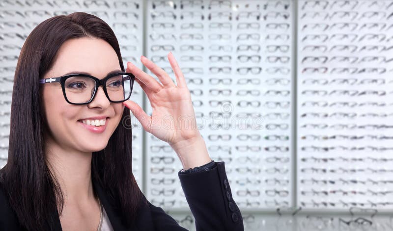 Eyesight And Vision Concept Happy Woman Trying On Glasses At Optics