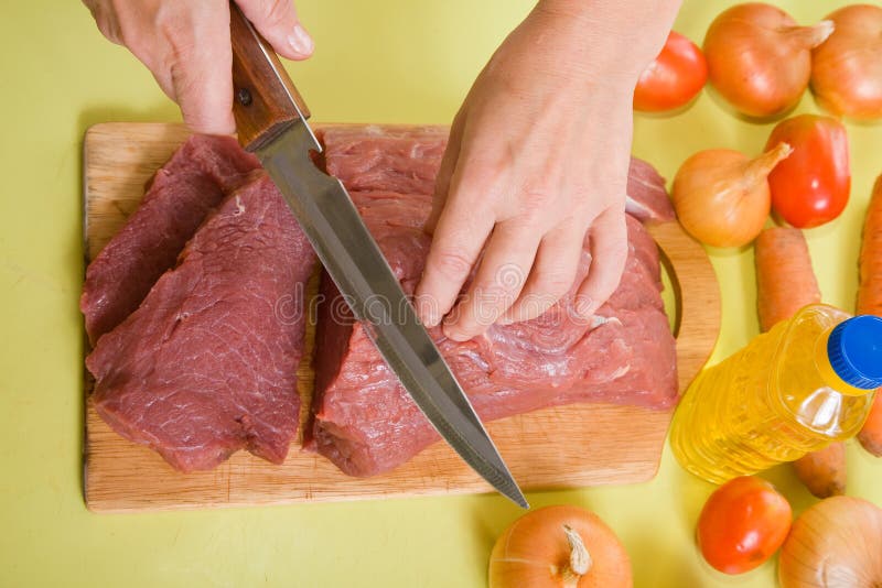 The Cook Hands Cut with a Knife Fresh Bread on a Kitchen Cutting Board ...