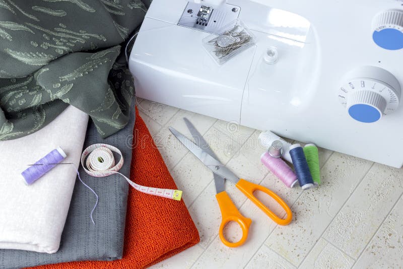 Fabric, Scissors, Sewing Machine and Various Sewing Supplies on a ...