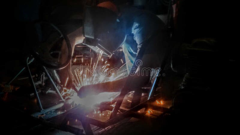 Fabricator welding a frame stock photo. Image of building - 168982994
