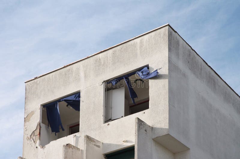 Facade of an Abandoned Building with Collapsed Window and Broken Blue ...