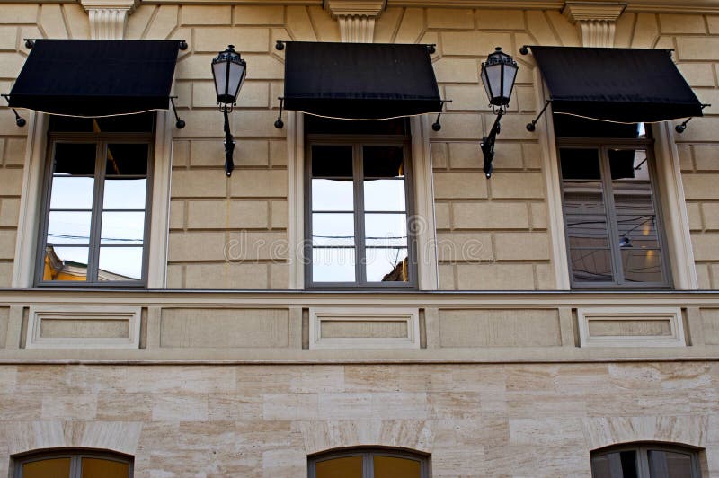 Tan Building with Red Awnings Stock Photo - Image of headquarters ...