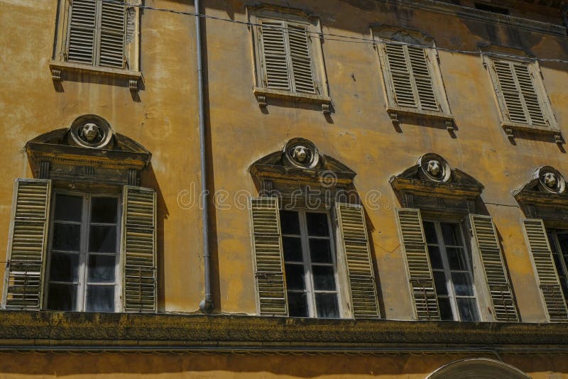 Facade of the Baroque Yellow Building with Windows and Shutters and ...