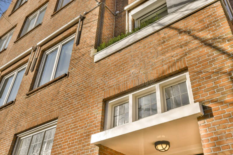 The Facade of a Brick Building with Windows Stock Photo - Image of ...