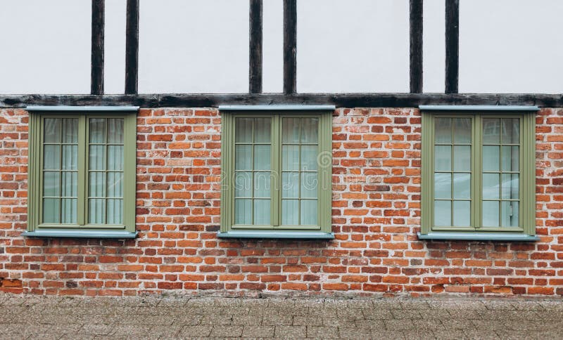 The Facade of a Brick House with Identical Square Windows. Brick Wall ...