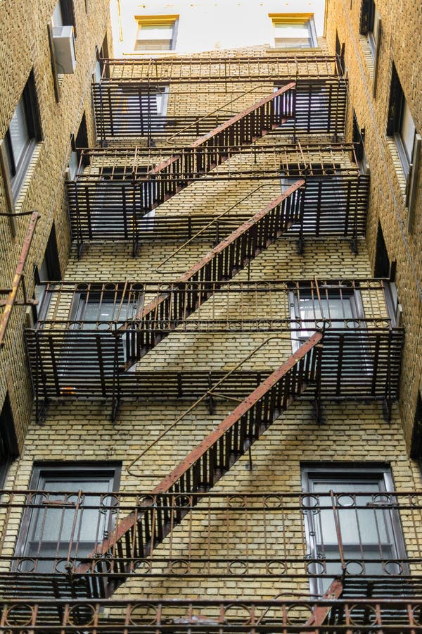 Facade of a Brownstone with Old Rusty Fire Escape Stock Photo - Image ...