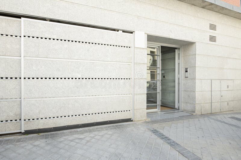 Facade of a Building with an Access Portal and a Folding Garage Door ...