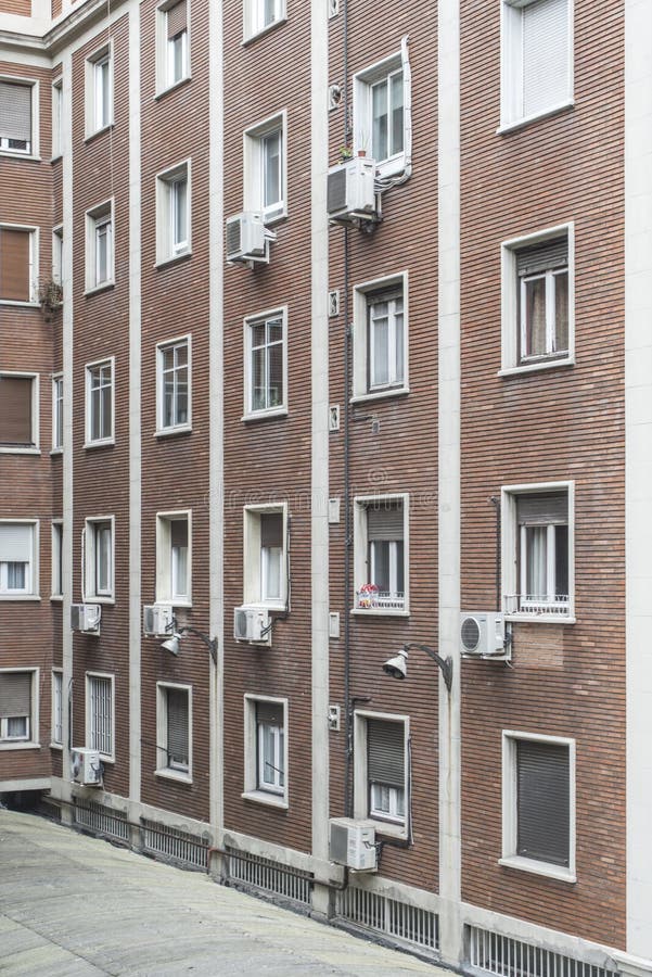 Facade of a Building with Exposed Clay-colored Brick, Windows with Air ...