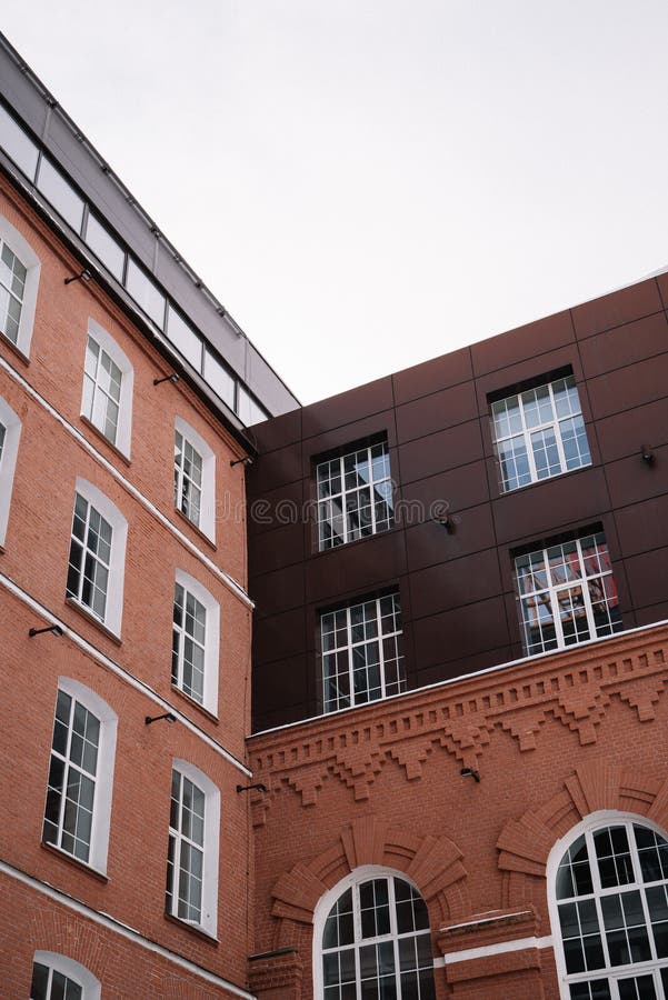 The Facade of the Building is Made of Red and Brown Bricks. Angular ...