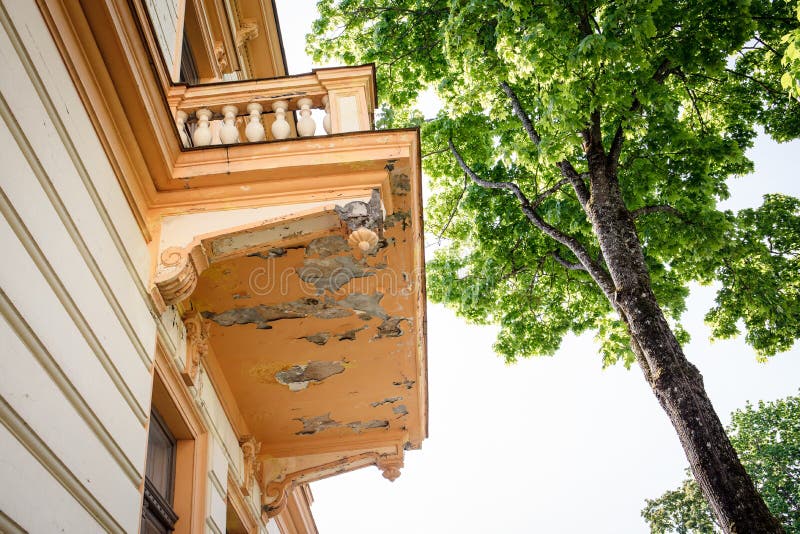 The Facade of the Building in Poor Condition. Balcony with Peeling ...