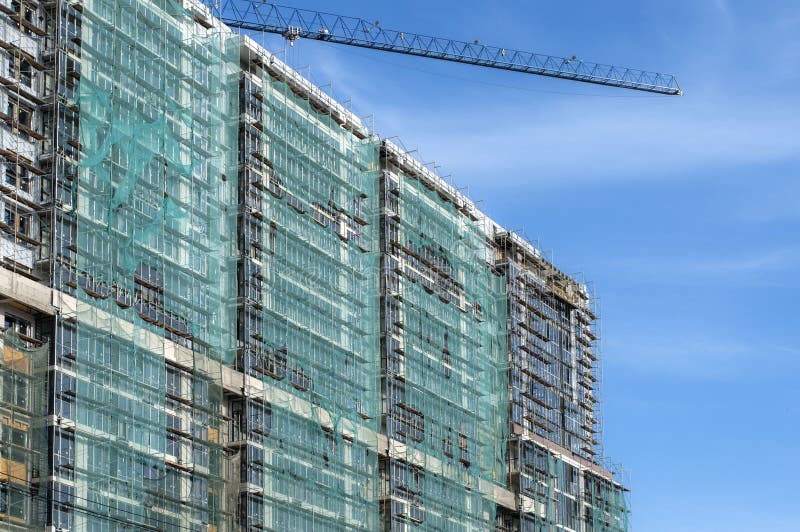 Facade of a Building Under Construction with a Protective Mesh Stock ...