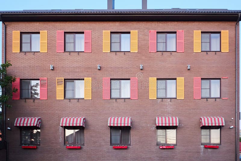 The Facade of the Building with Windows of Different Shapes. Stock ...