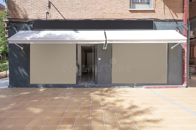 Facade of a Commercial Premises with Awnings on the Basement Stock ...