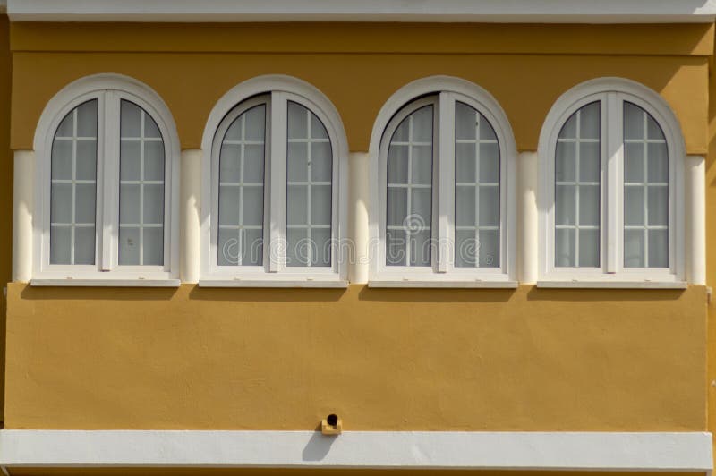 Facade of a House with Four White Windows with a Rounded Shape in the ...