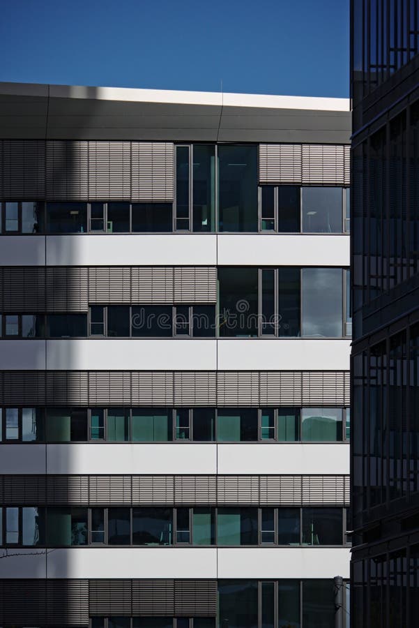 Facade of High-rise Office Building Partly Lit by Sunlight with Second ...