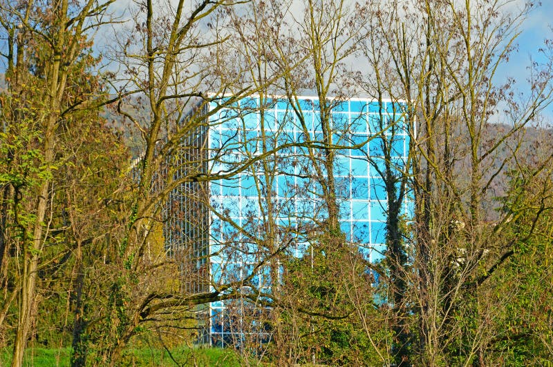 The Facade of a Modern Blue Building among Trees Stock Image - Image of ...