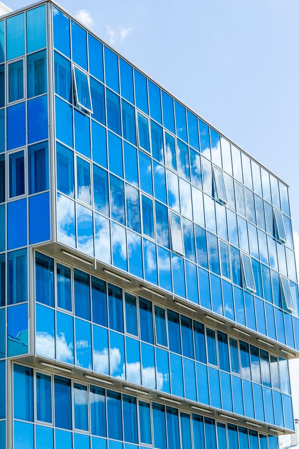 Facade of a Modern Building. Glass Windows Reflected the Sky and Clouds ...
