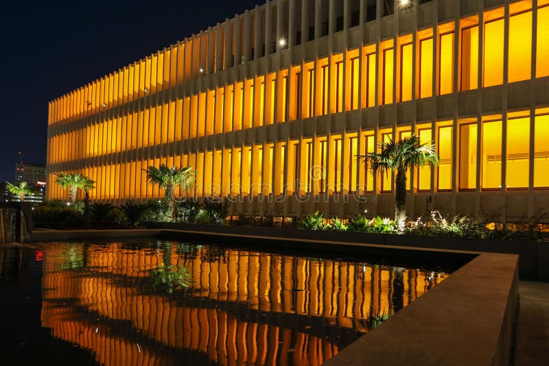 Facade of Modern Building at Night with Yellow Lights Shining through ...