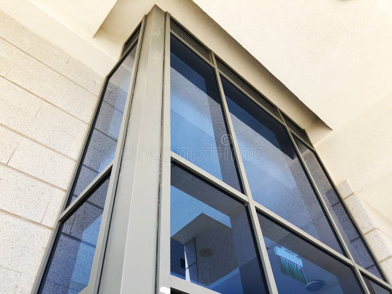 Facade of Modern Building with Rectangular Turquoise Glass Bay Windows ...