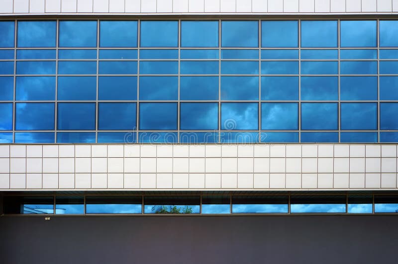 Facade of Modern Building. Reflection of Sky with Clouds in Windows ...