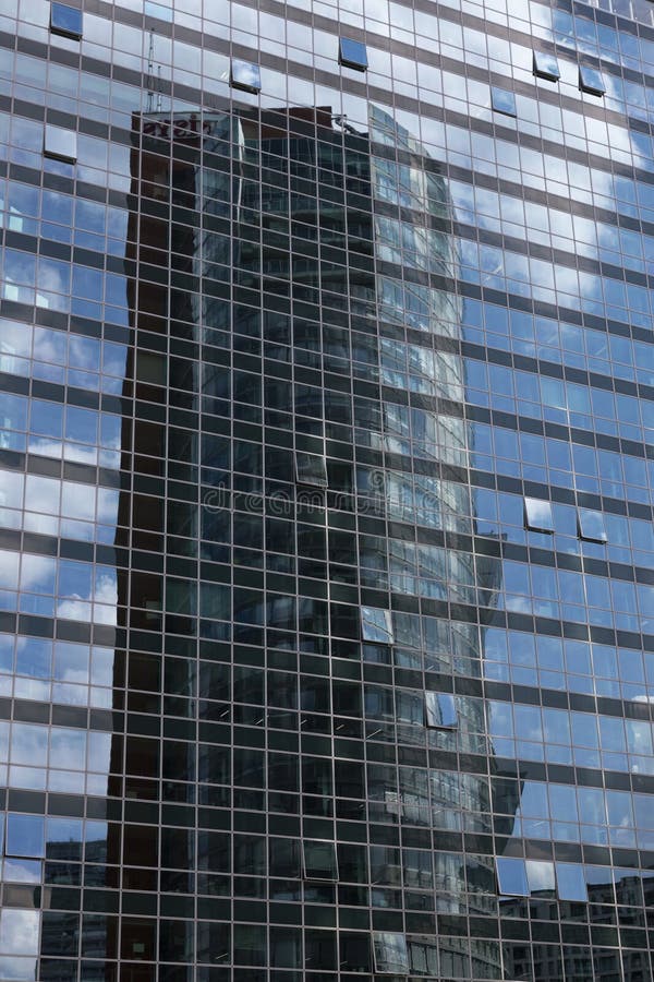 The Facade of a Modern Multi-storey Building with Reflections in the ...
