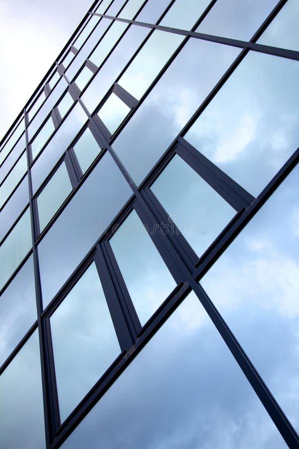 Facade of Office Building with Overcast Sky Reflected Stock Photo ...