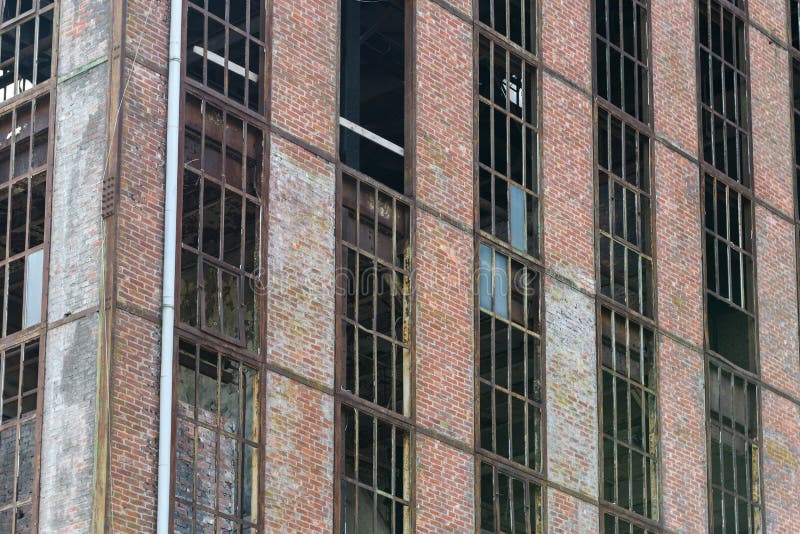 Facade of an Old Abandoned Factory. Rusty Windows without Glass Stock ...