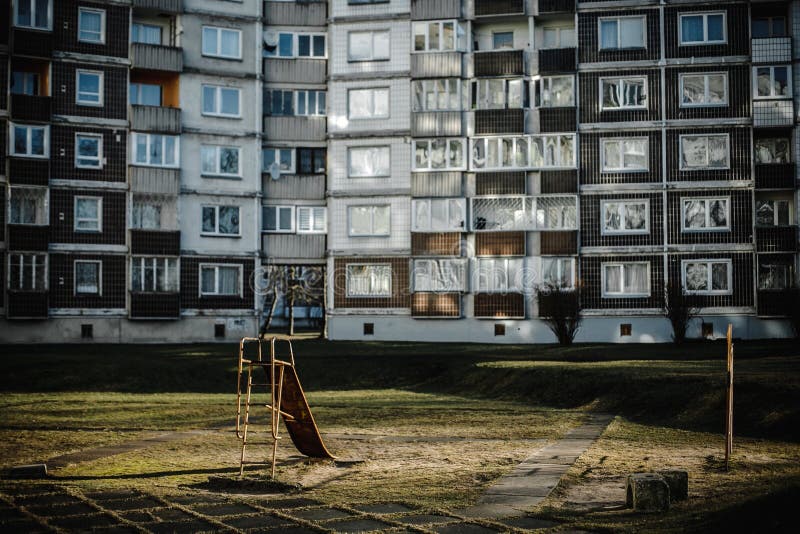 Facade of Old Apartment Buildings, with an Old Slide in Front Stock ...