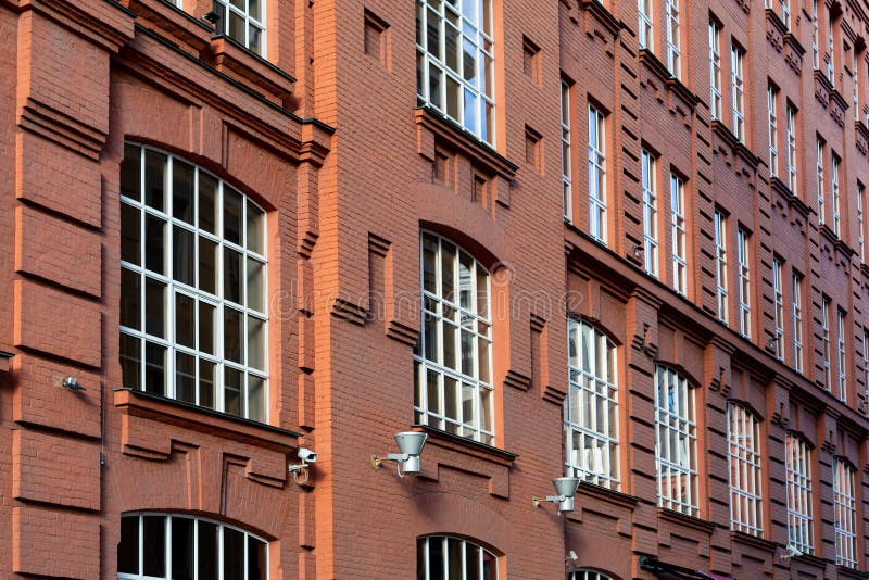 Facade of Old Classic Red Brick Building with Large Windows with White ...