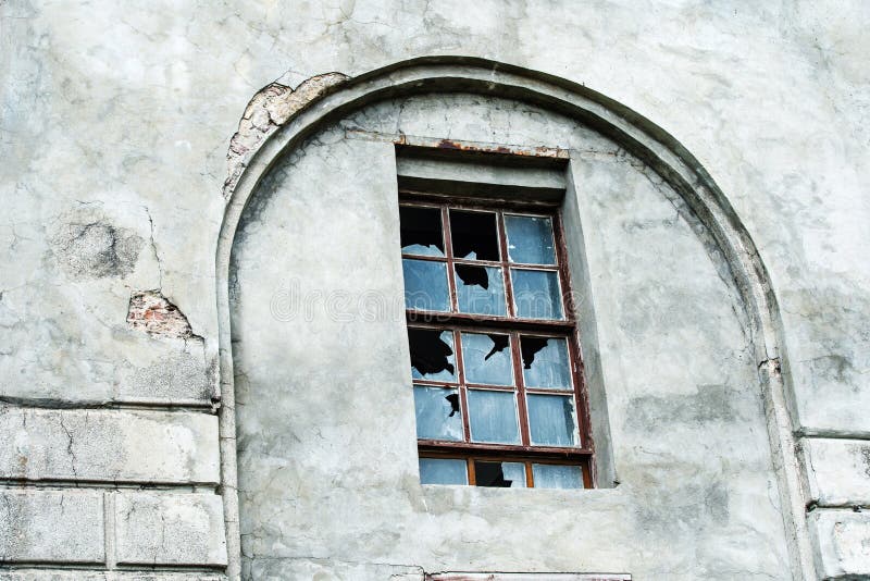 The Facade of an Old House with Broken Windows. Gray Wall with ...