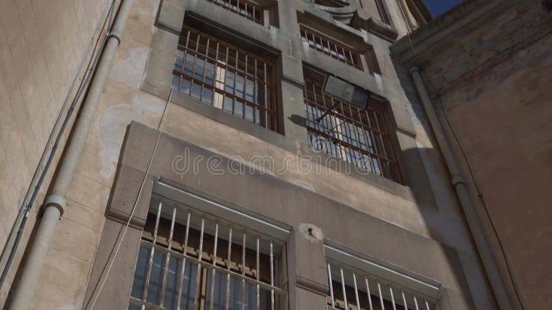 Facade of the Prison Building with Spotlight on Wall and Bars on ...