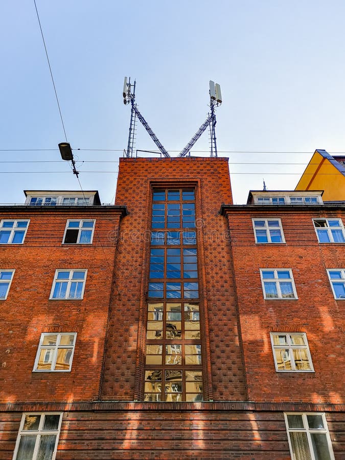 Facade of Red Brick Building with Blue Reflections in Windows and ...