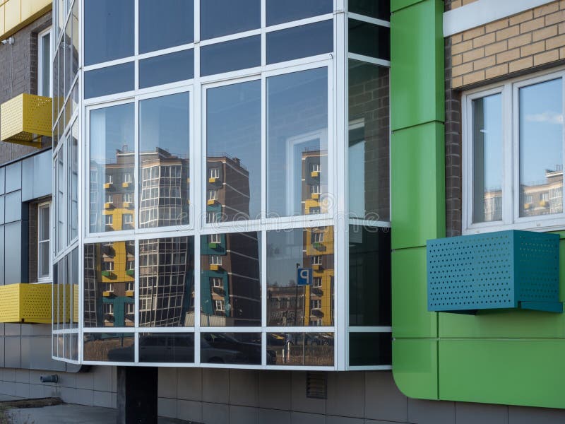 Facade with Reflective Windows and Colorful Elements in Modern ...