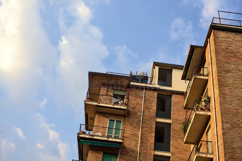 Facade and Roof of a Building Next To Trees with a Cloudy Sunset Sky As ...