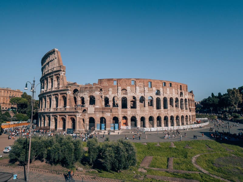 Facade Shot of the Colosseum in Rome, Italy Around Grass Fields Under a ...