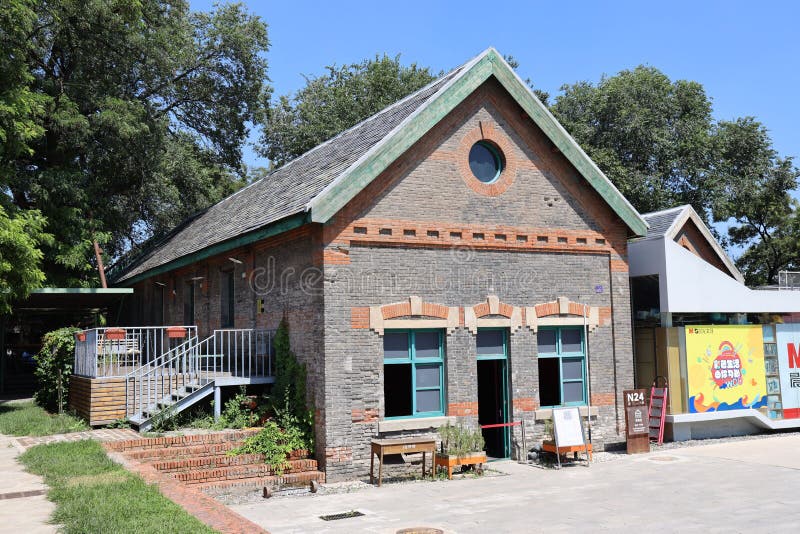 Facade of a Small Brick Building with Trees Behind it on a Sunny Day ...