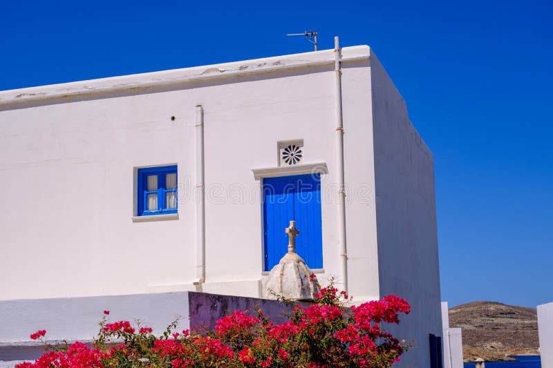 Facade of a Whitewashed House with Blue Windows, and Bougainvillea ...