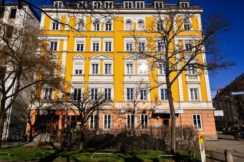 Facade of a Yellow Building with White Windows from the Street ...
