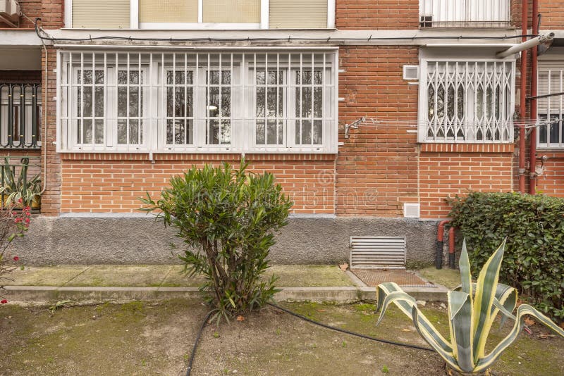 Facades of Conventional Brick Residential Building with a Garden Under ...