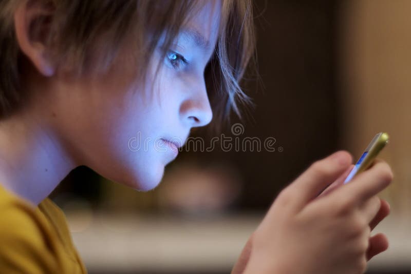 The Face of the Child, Illuminated by the Screen of the Phon Stock ...
