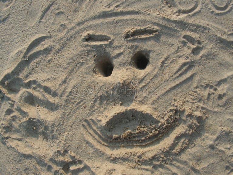 Face drawn in sand stock photo. Image of beach, sand, face - 1137658