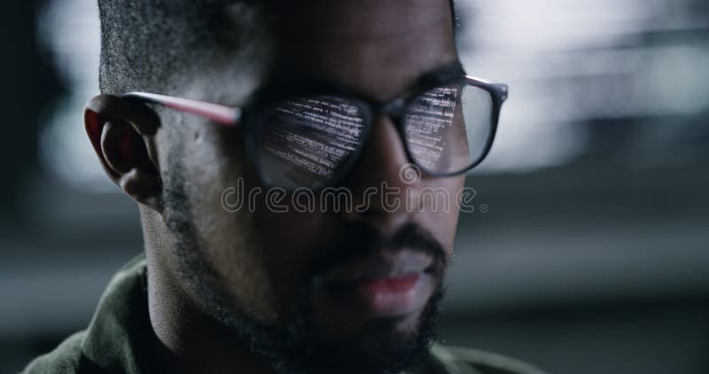 Face, Glasses and Code with a Black Man Programmer Working in a Dark Office for Data Processing ...