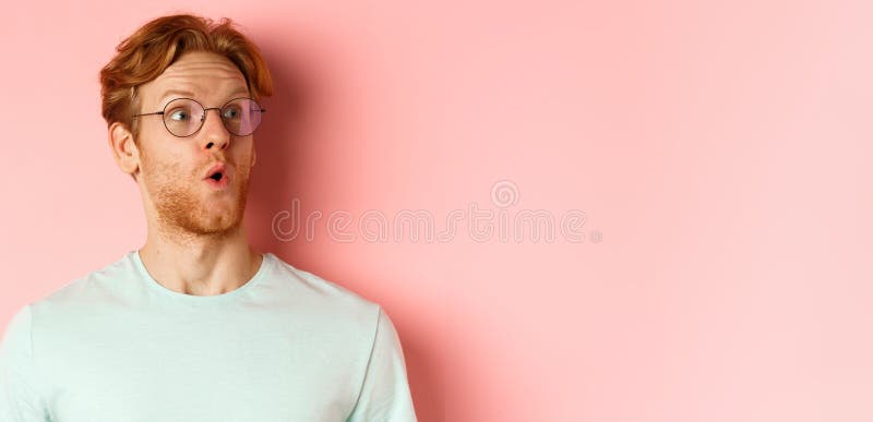 Face Of Intrigued Young Man With Ginger Hair And Beard Raising