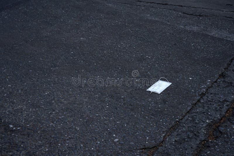 A Face Mask Dropped on the Ground Stock Photo - Image of face, lifted ...