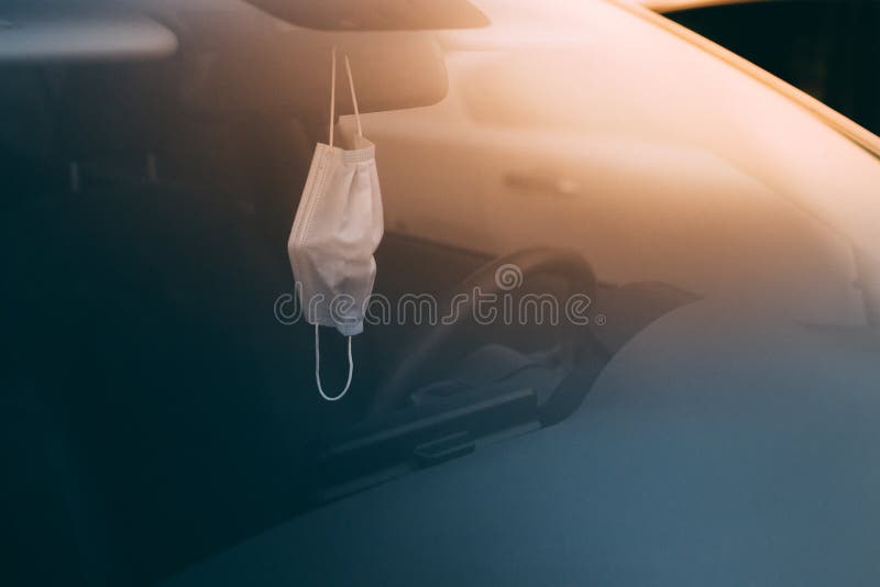 Face Mask Hanging on Rear View Car Mirror Stock Photo - Image of ...